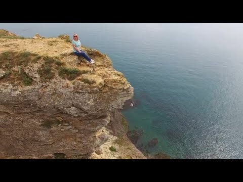 Girl Sits On Cliff Stock Video