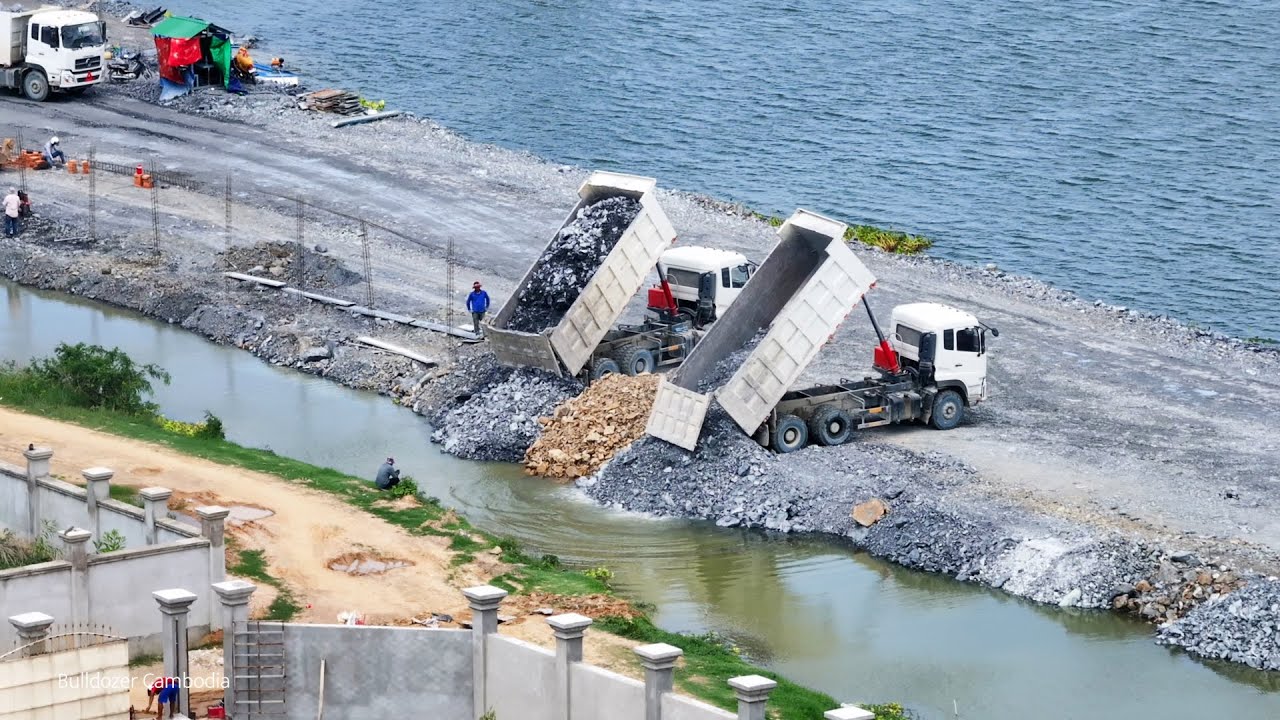 FULL PROCESS OF SUCCESSFULLY POURING STONES ON THE WATER NEXT TO THE ...