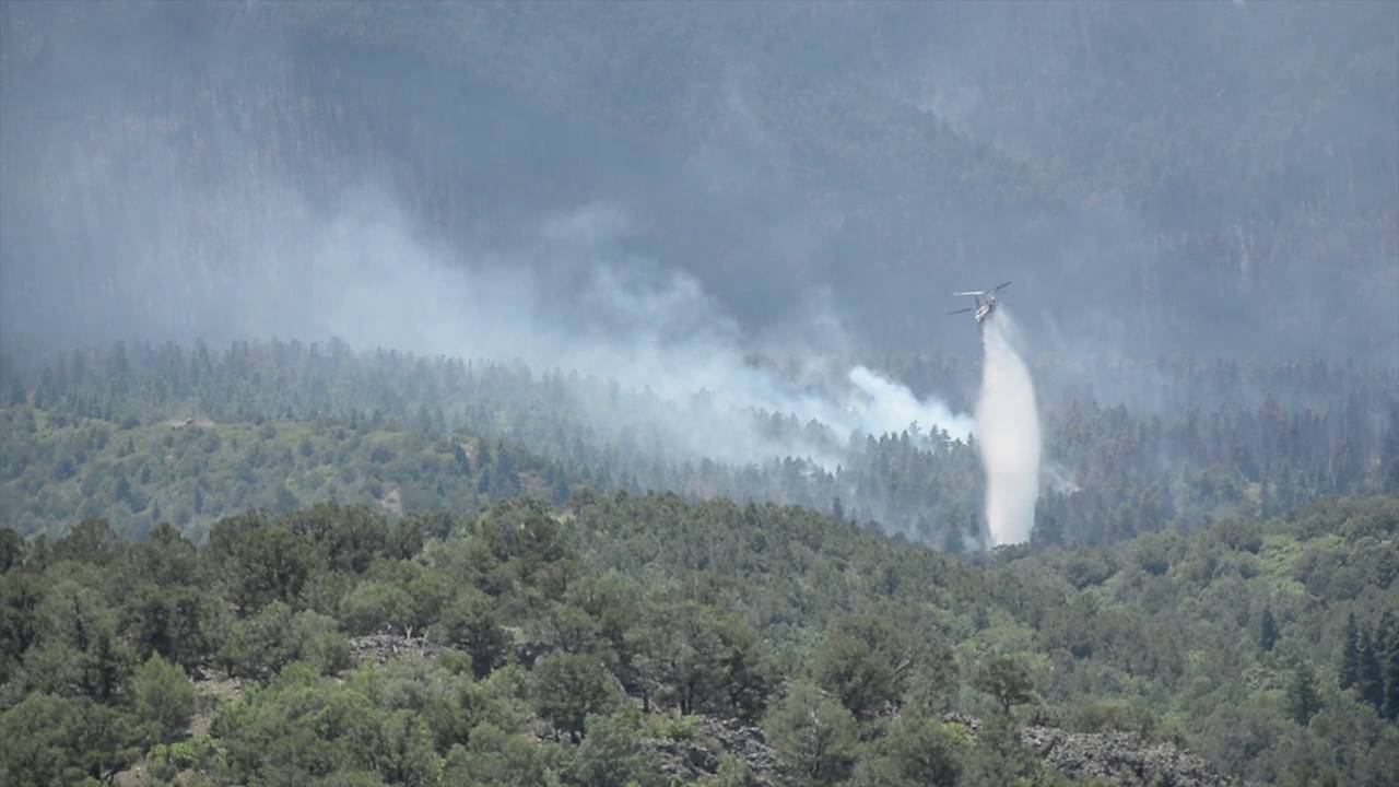 Helicopter drops water on Hayden Pass Fire - YouTube