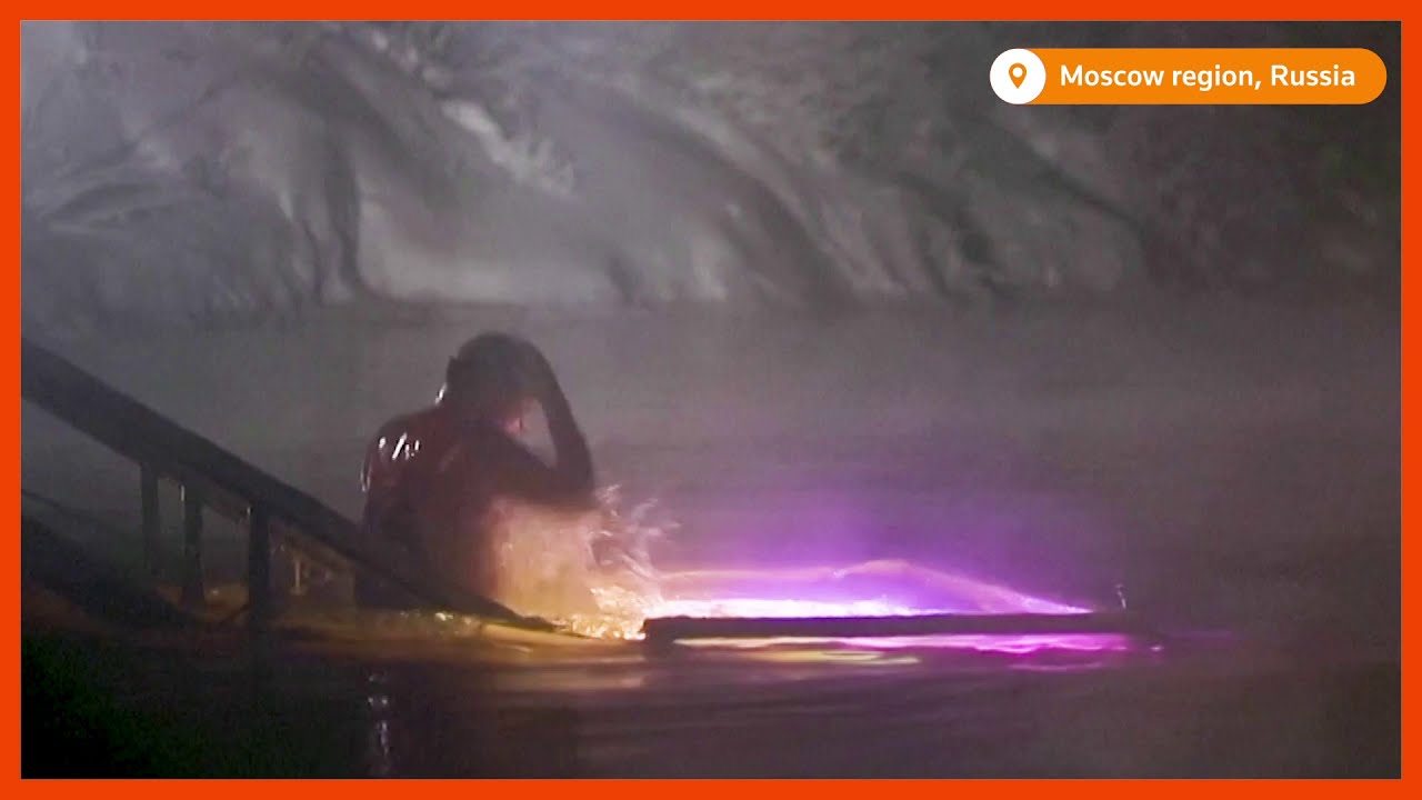 Russians dip into ice-cold water for Epiphany - YouTube