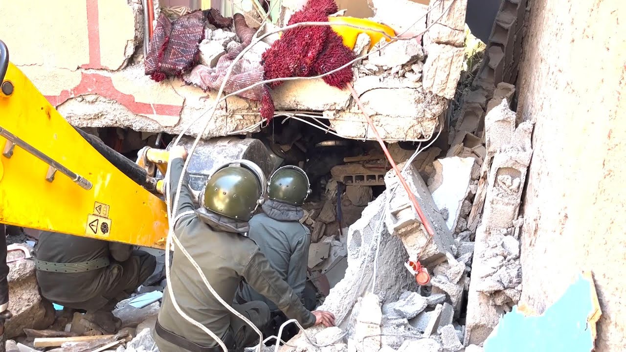 Firefighters work to rescue people trapped under the rubbles in Morocco ...