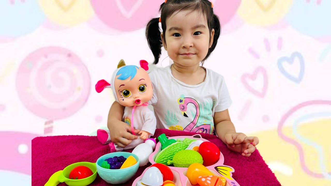 Malika plays with a doll - YouTube