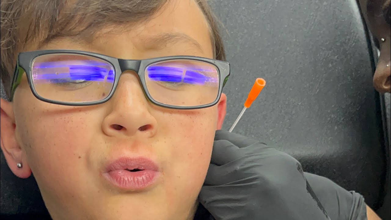 Getting his ears pierced. So brave - YouTube