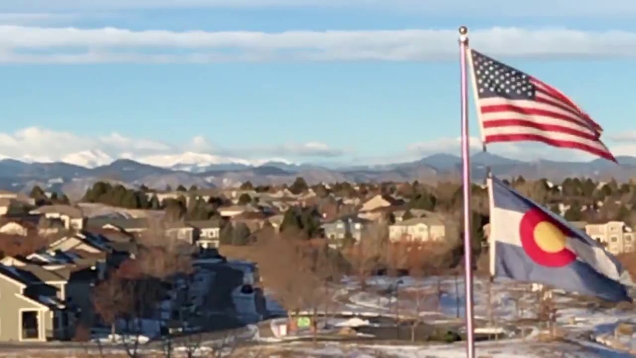 iHonor Flag and Colorado Flag flying at sunrise in slow motion - winter ...