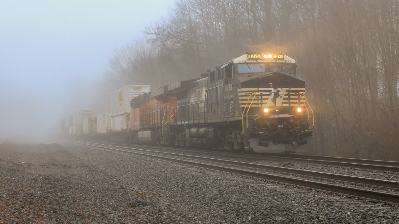 NS 28M emerges from the fog with a NS C6M and a BNSF ES44C4 at Towners ...