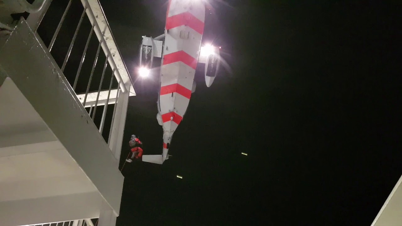 Helicopter air rescue operation hoist/winching at night from DFDS ...