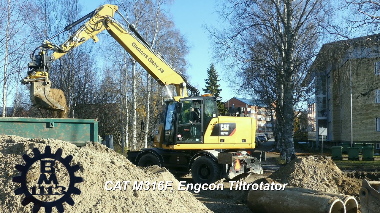 CAT M316F with Tiltrotator in Pipe work and Loading truck - YouTube