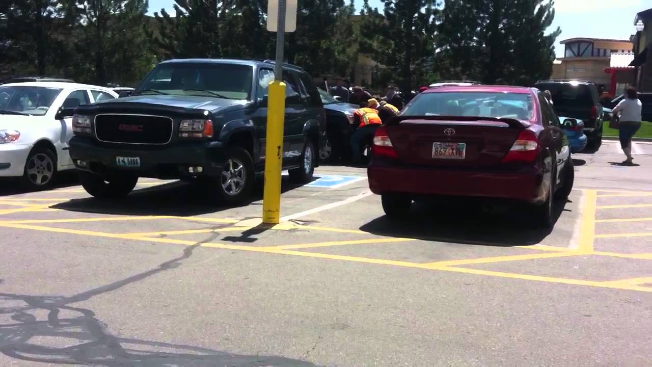 People lifting car up off of woman at Costco - YouTube