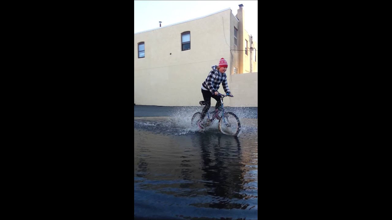 Jessie rides bike through puddle - YouTube