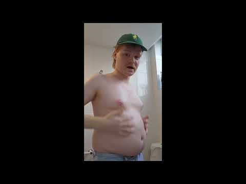 Fat gainer boy talking and rubbing sunscreen on his belly