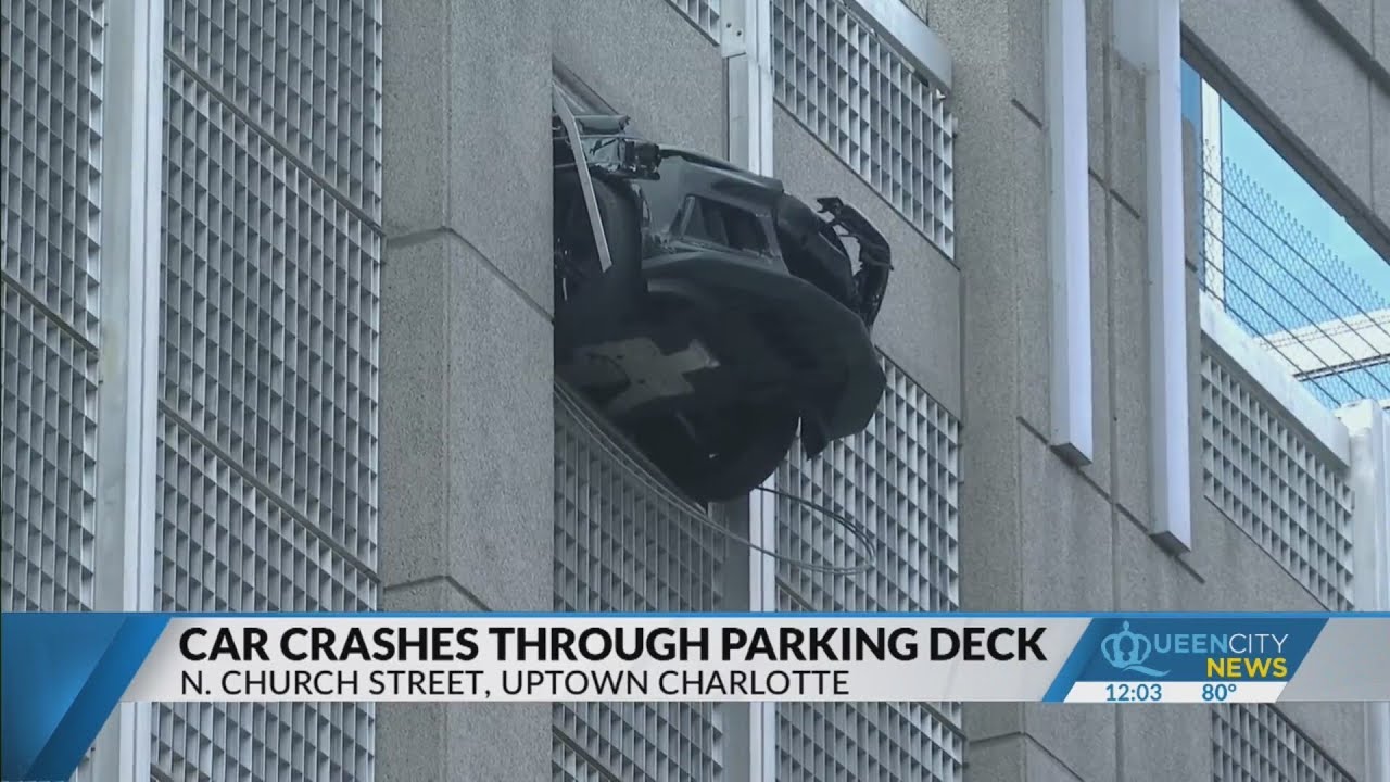 Vehicle dangles from uptown Charlotte parking deck - YouTube