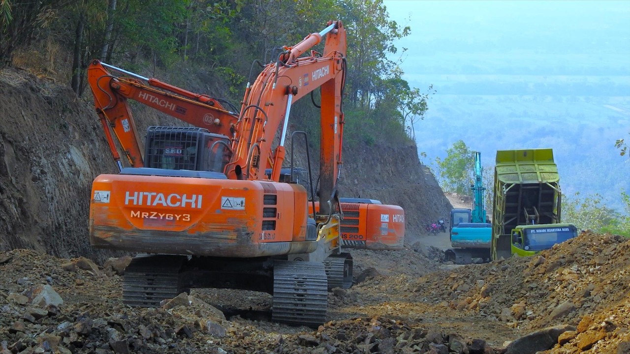 Hitachi Excavator Excavating the Cliff to Build a New Winding Road on ...