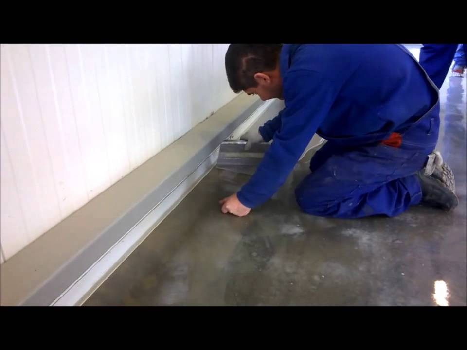 Applying epoxy resin flooring within the substrate-to-wall junction ...