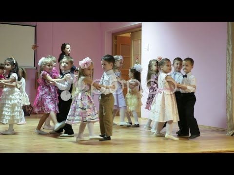 Preschooler children dancing in pairs on the kindergarten stage, Russia. Stock Footage