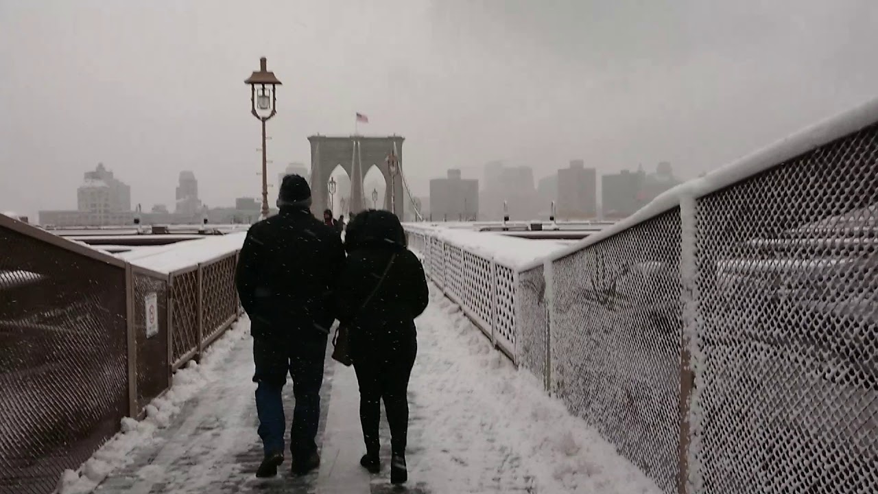 Walking on and across the Brooklyn Bridge during first Snow Fall Winter ...