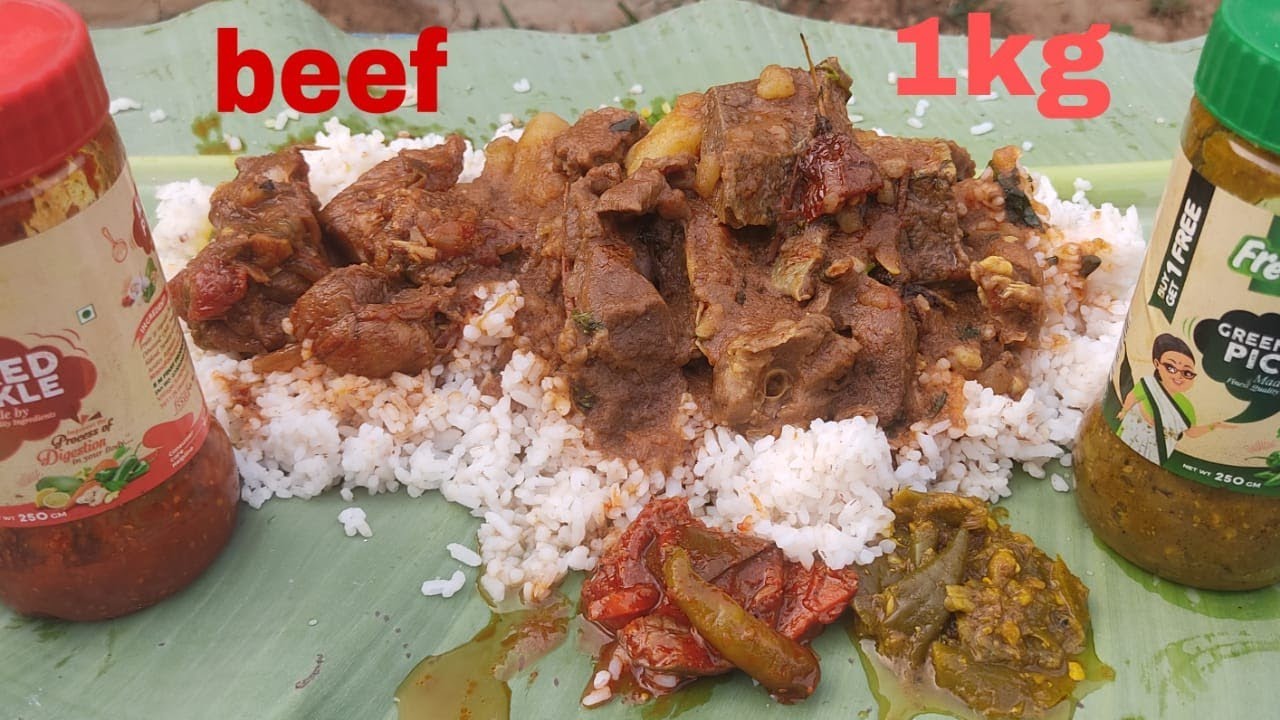 Eating delicious beef/buff curry with mixed pickle and green chilli ...