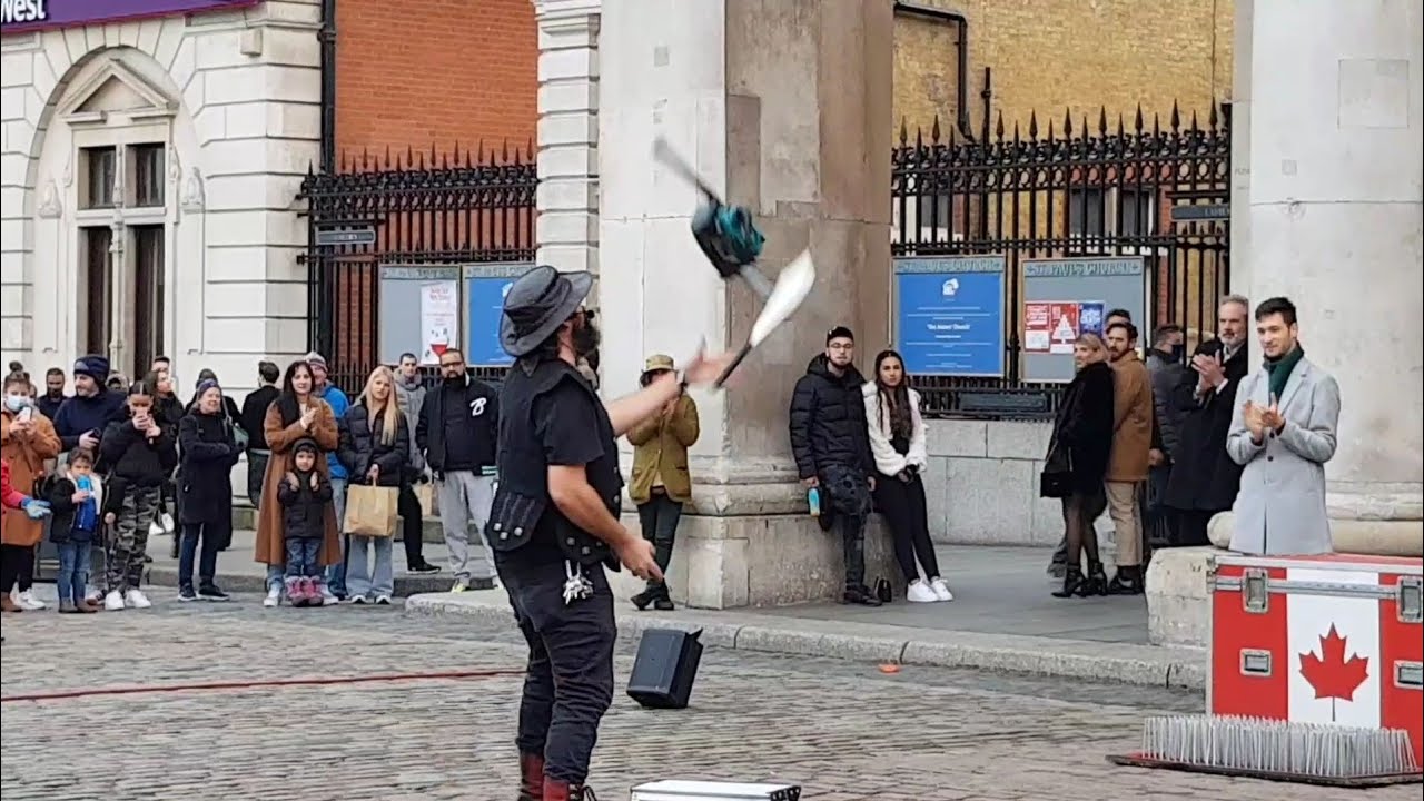juggling a chain saw at Covent garden - YouTube