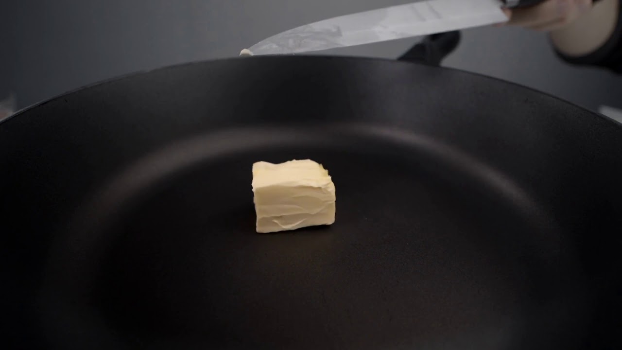 chef greases the hot pan with butter melting butter on the pan - YouTube