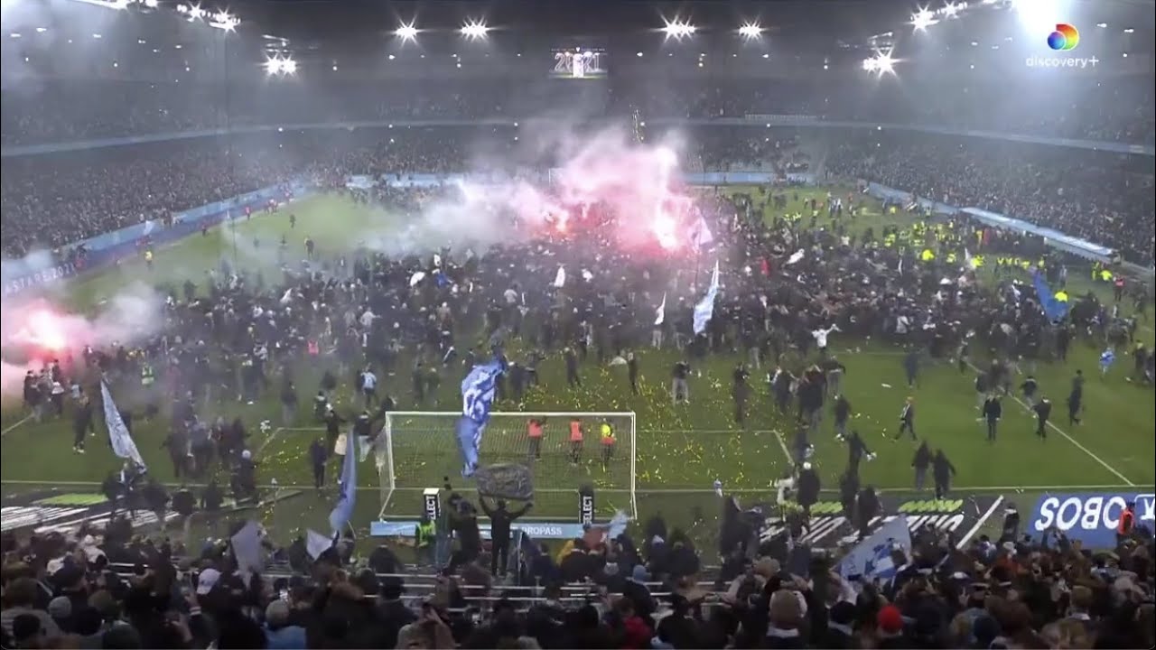 Malmo fans storm pitch and mob players with flares and fireworks after ...
