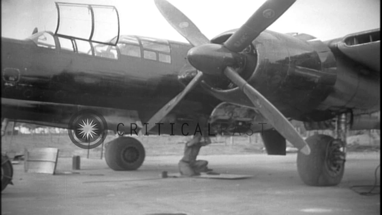 Crew members prepare a US P-61 (Black Widow) for night mission in ...