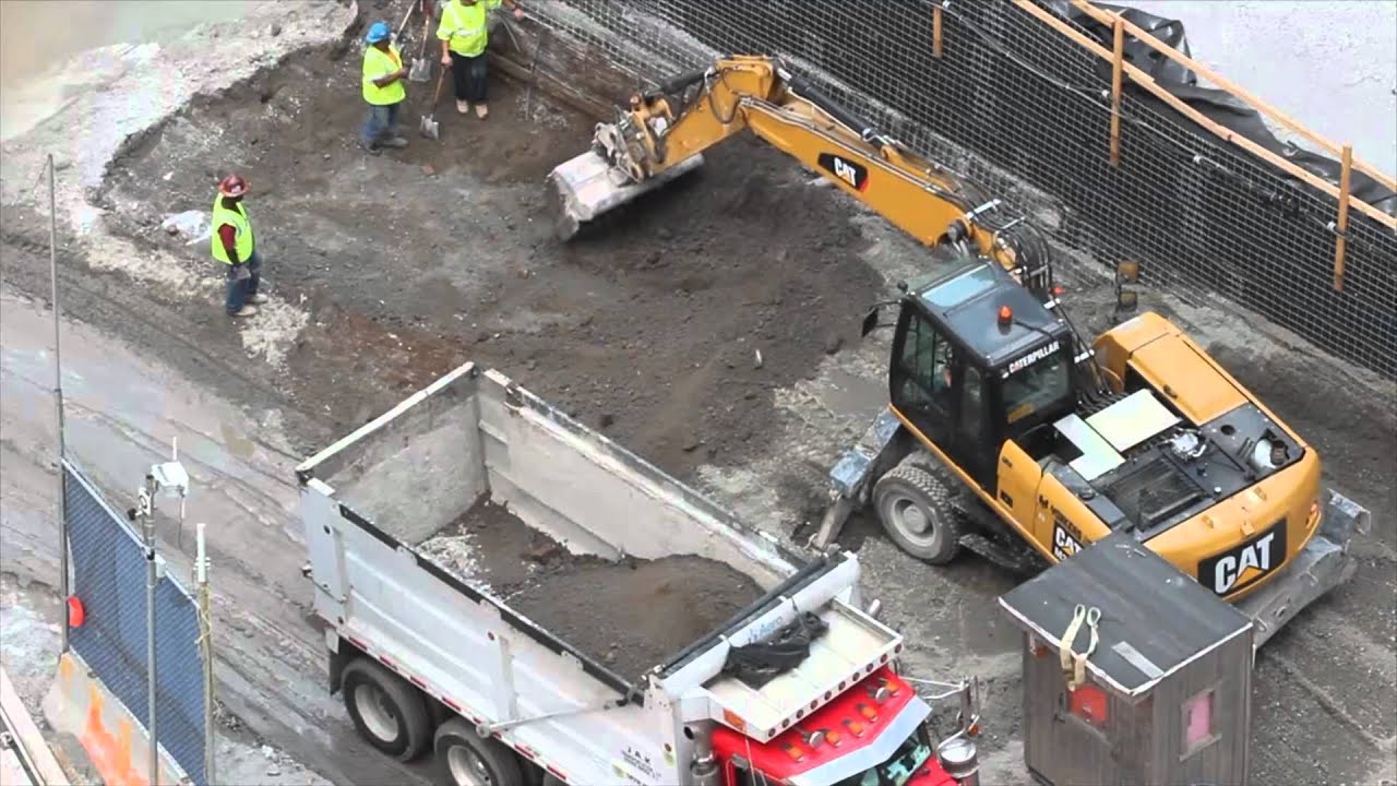 Cat M318D wheeled excavator loading truck # 2 - YouTube