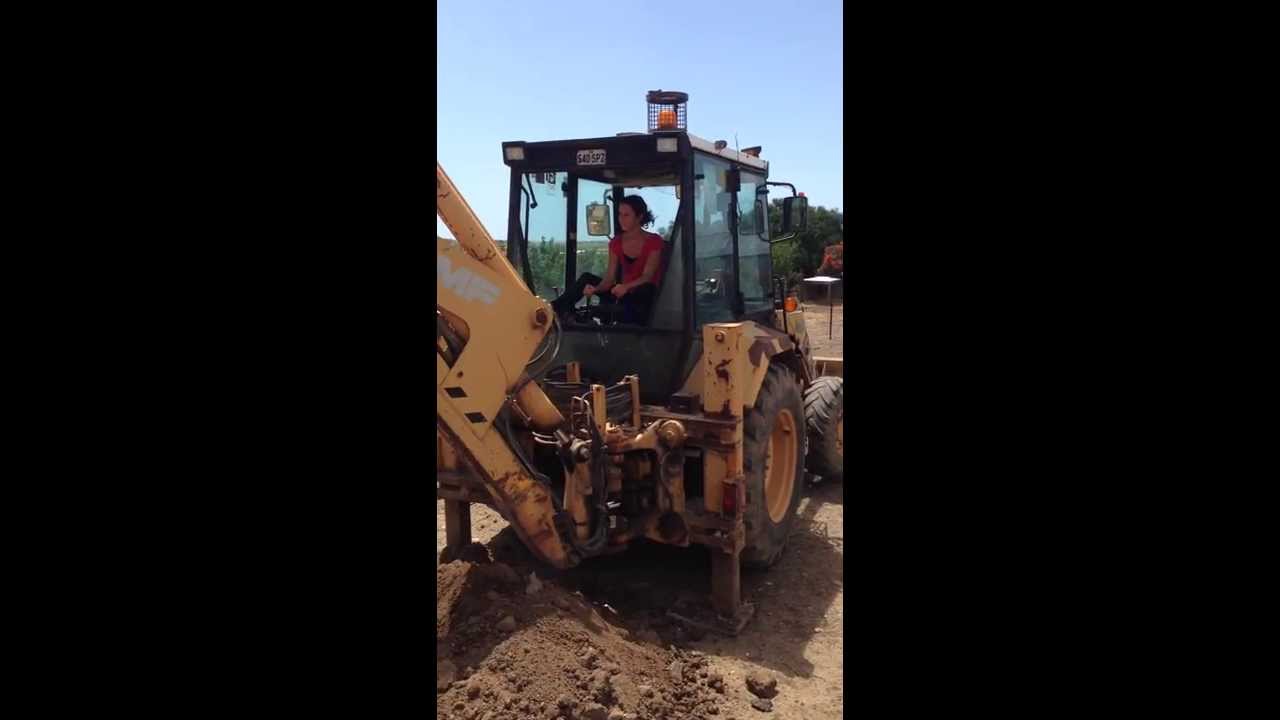 Learning how to drive a backhoe - YouTube