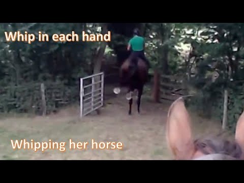 WHIPPING her horse, using a dressage whip in each hand 🤬
