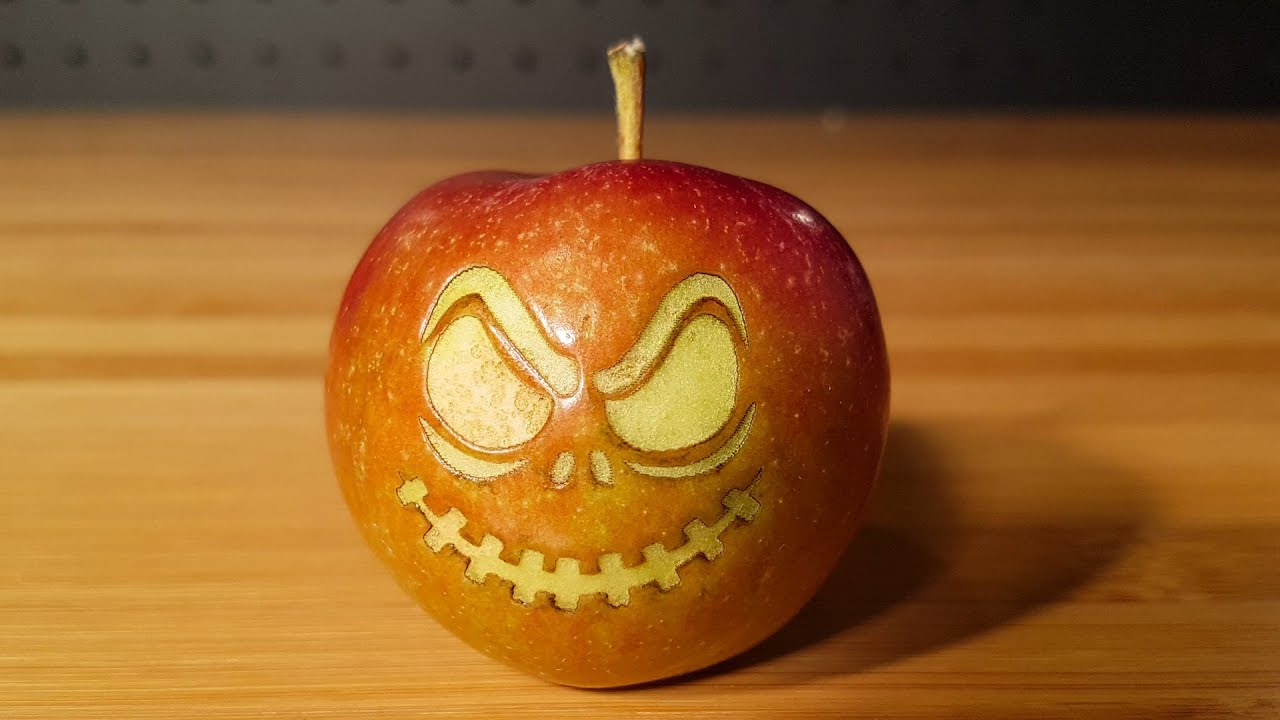 Laser engraving an Apple with a Halloween Theme Face - YouTube