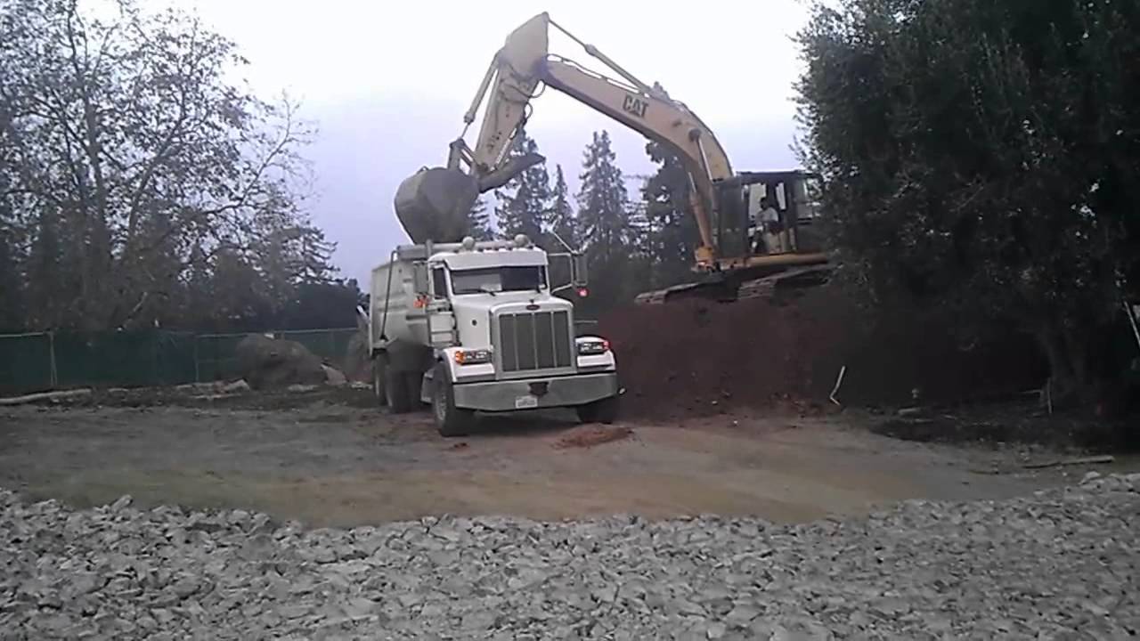 Loading A Dump Truck at a Construction Site - YouTube