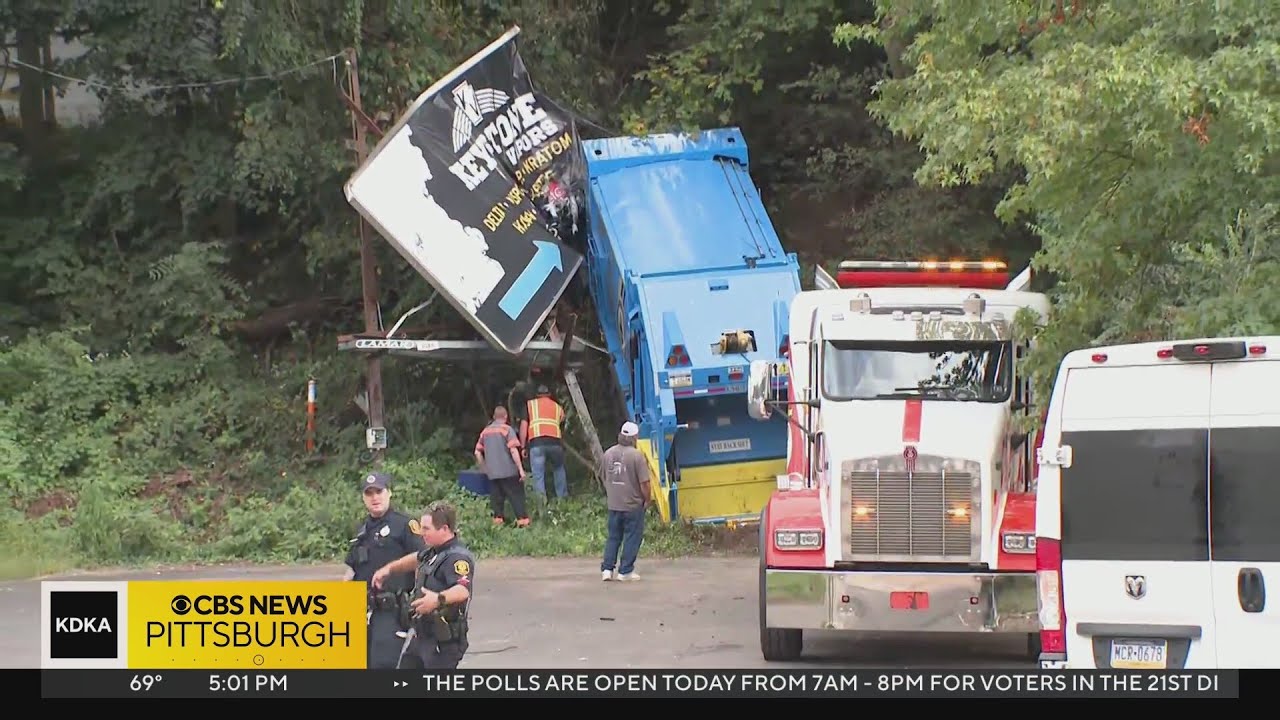 Driver of garbage truck crashes into billboard - YouTube