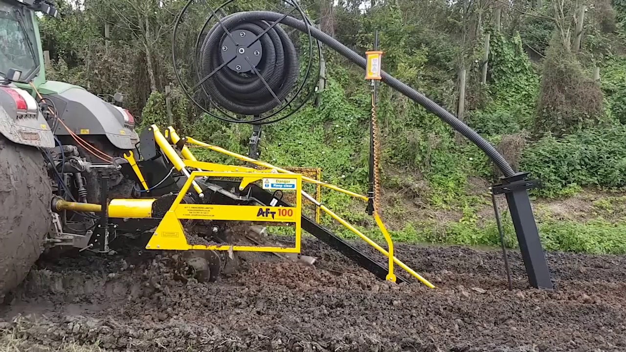 AFT100 trenching & laying drainge pipe in heavy clay & very wet ...