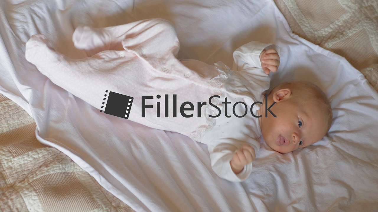 Active awake baby girl of two months on bed - YouTube