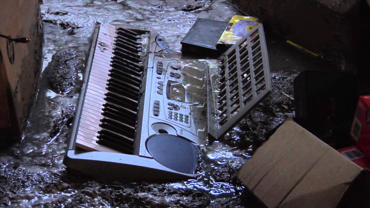 Flood waters filled with hail and debris destroy basement - YouTube