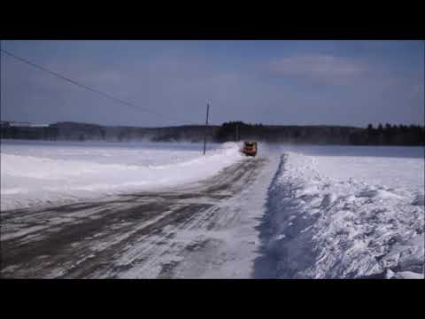 snow plow plows large snow drifts on road,Febuary,2019,Woodstock,NB ...