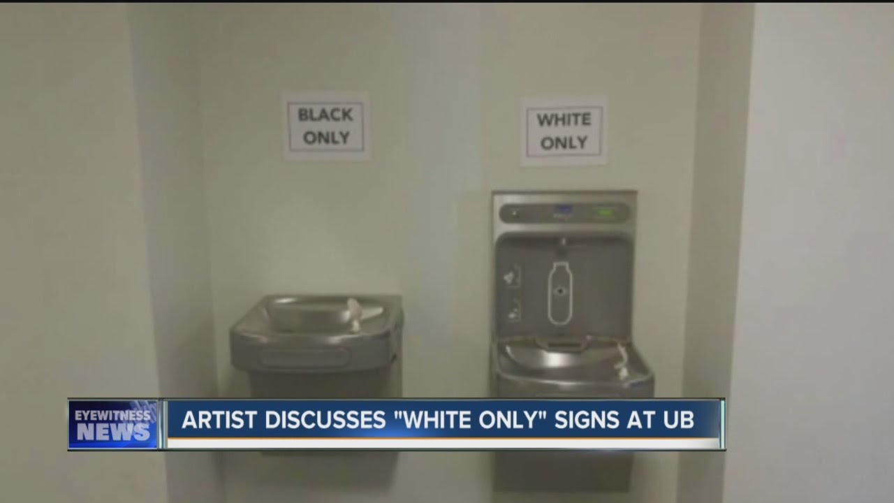 Artist behind "white only" signs talks to 7 - YouTube