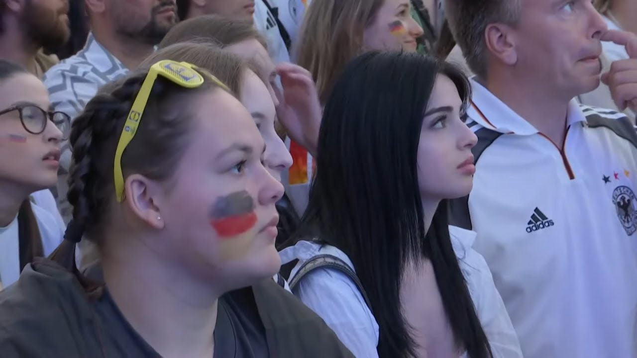 German fans in a Berlin fan zone cheer on Germany against Switzerland ...