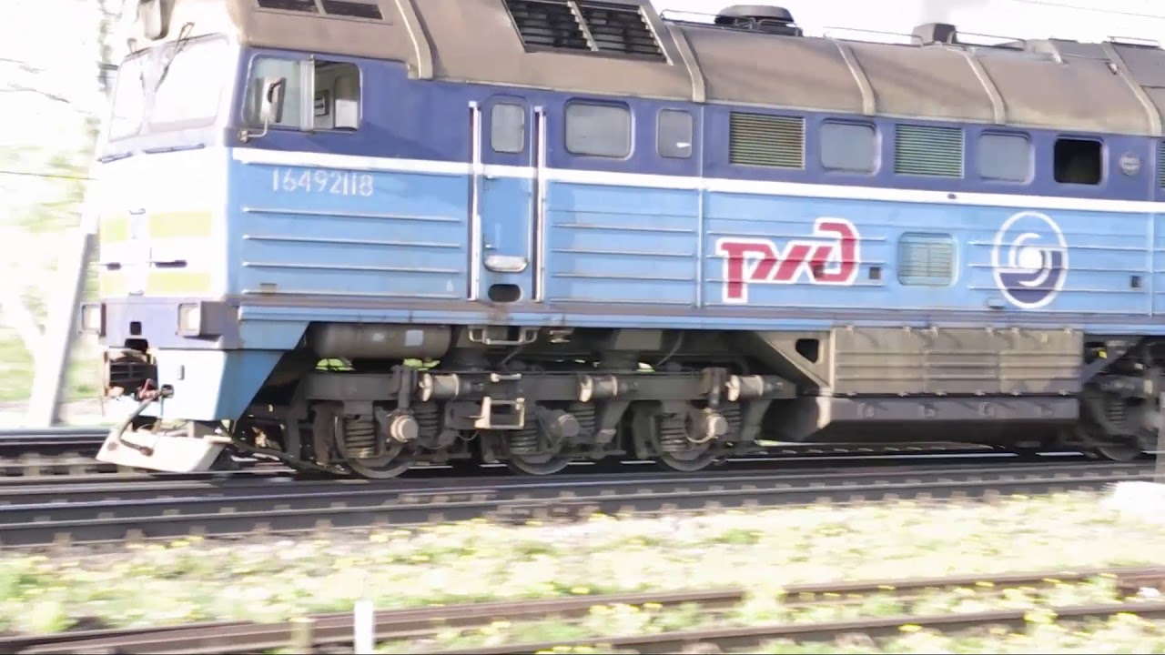2TE116 diesel locomotive with train departuring Gatchina cargo train ...