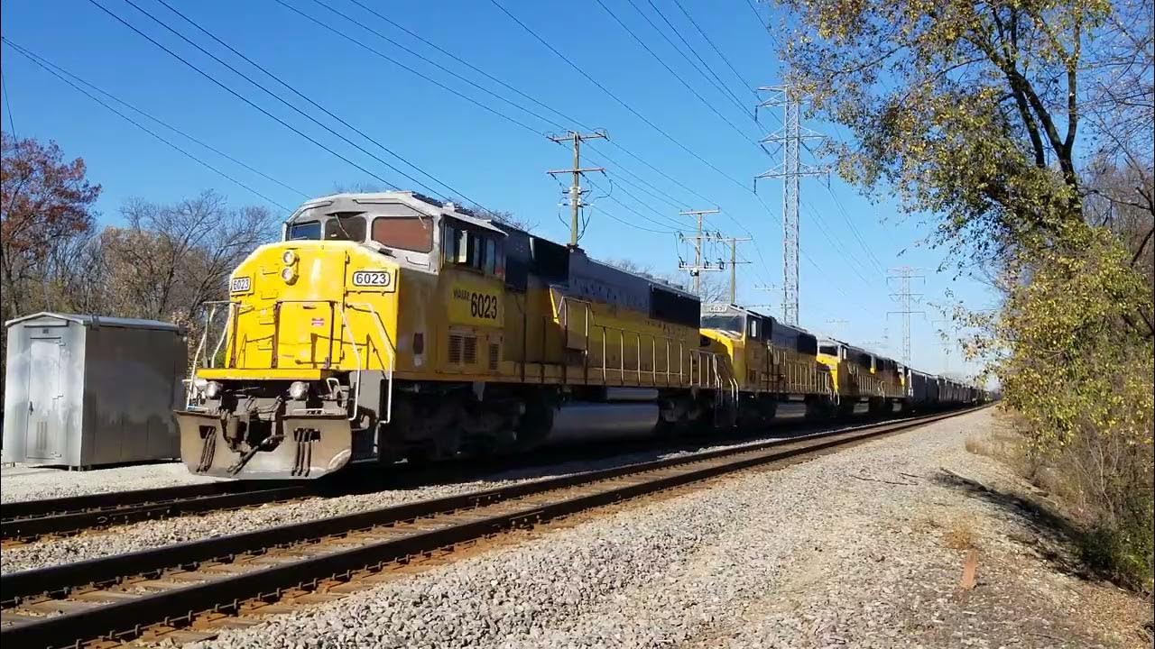 WAMX 6023 + 3 more SD60Ms lead a rare daylight T004 through Morton Grove - YouTube
