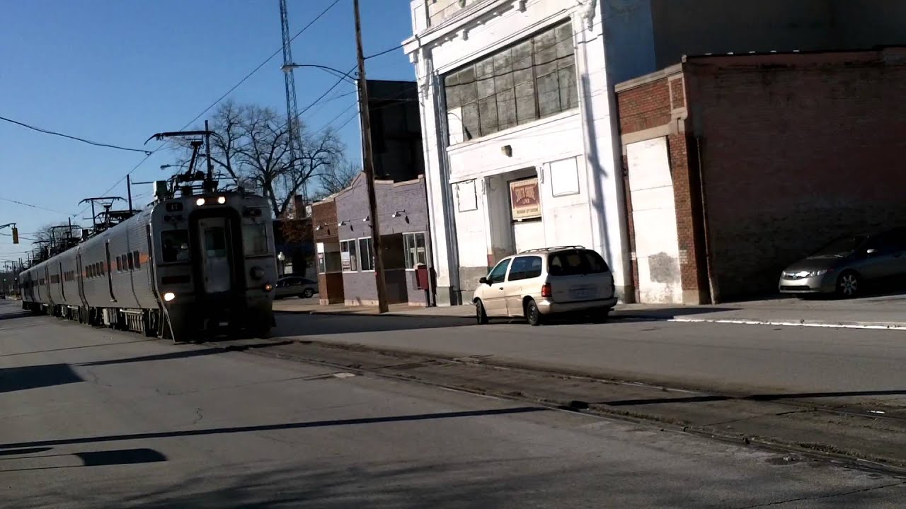 CSS 17 leads NICTD train #603 down 11th St in Michigan City, IN - YouTube