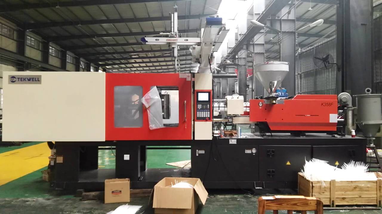 Cable tie injection molding machine with robot arm - YouTube