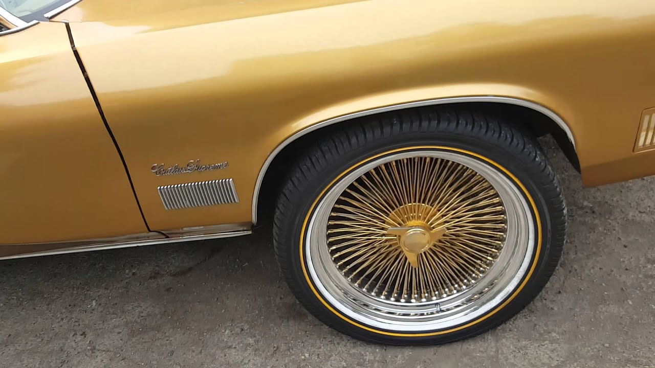 75 cutlass on 22 inch gold thangs - YouTube