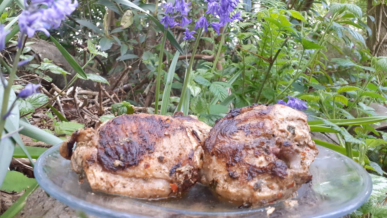 Bushcraft cooking in the woods. Over the fire cooking. Chicken tandoori ...