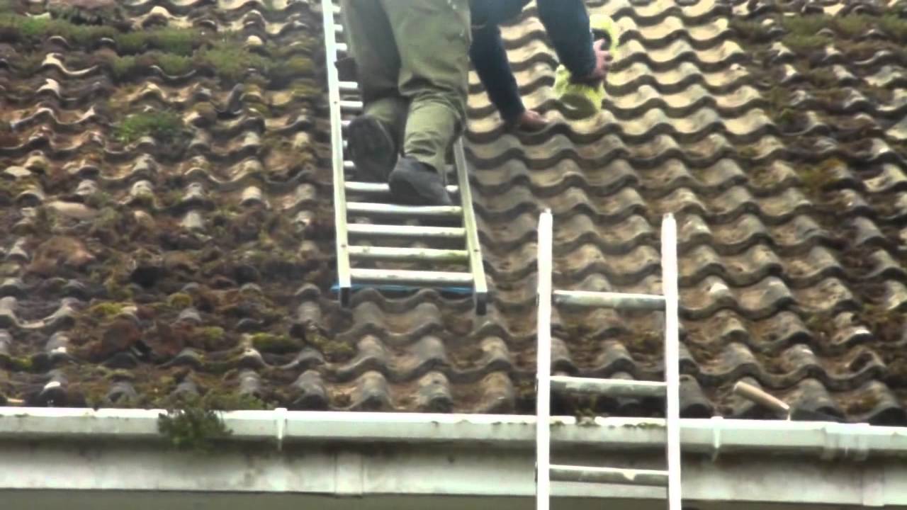 Scraping a roof ready for soft washing - YouTube