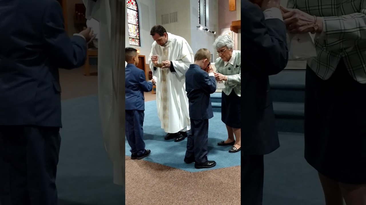 Christopher receiving the host at his 1st holy communion. - YouTube