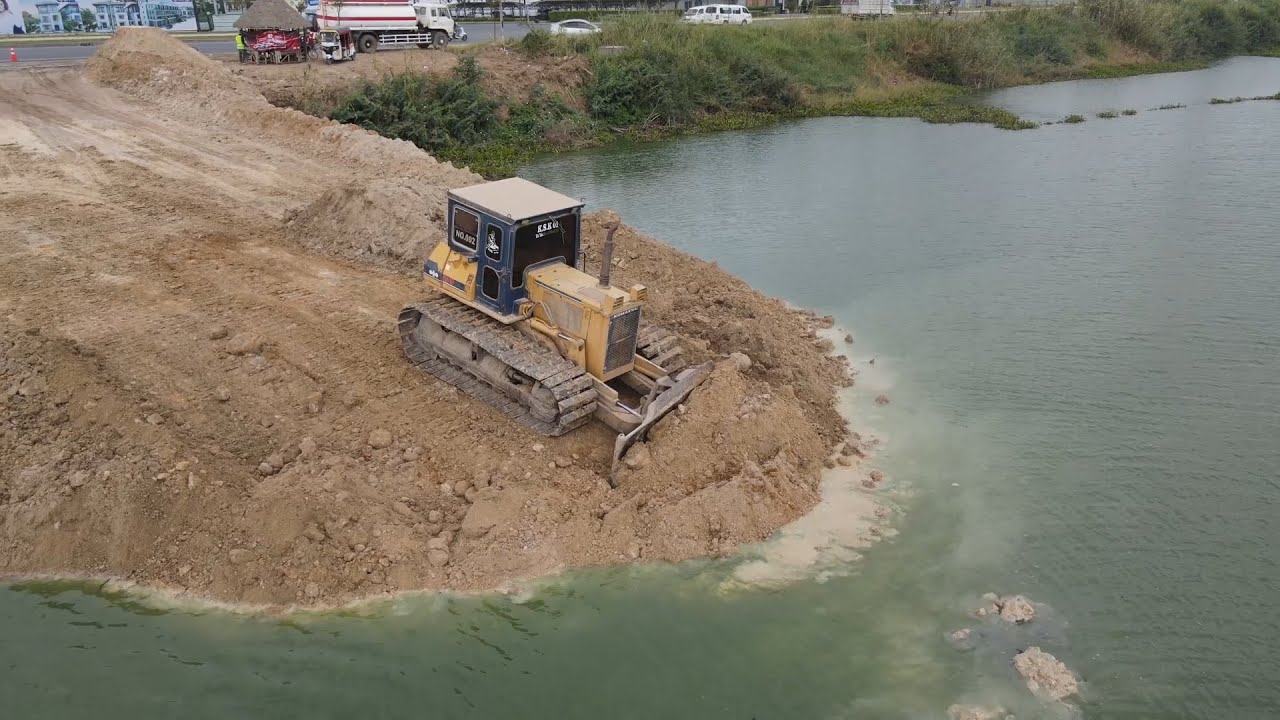 Amazing intelligent bulldozer driver skill push the land into big lake ...