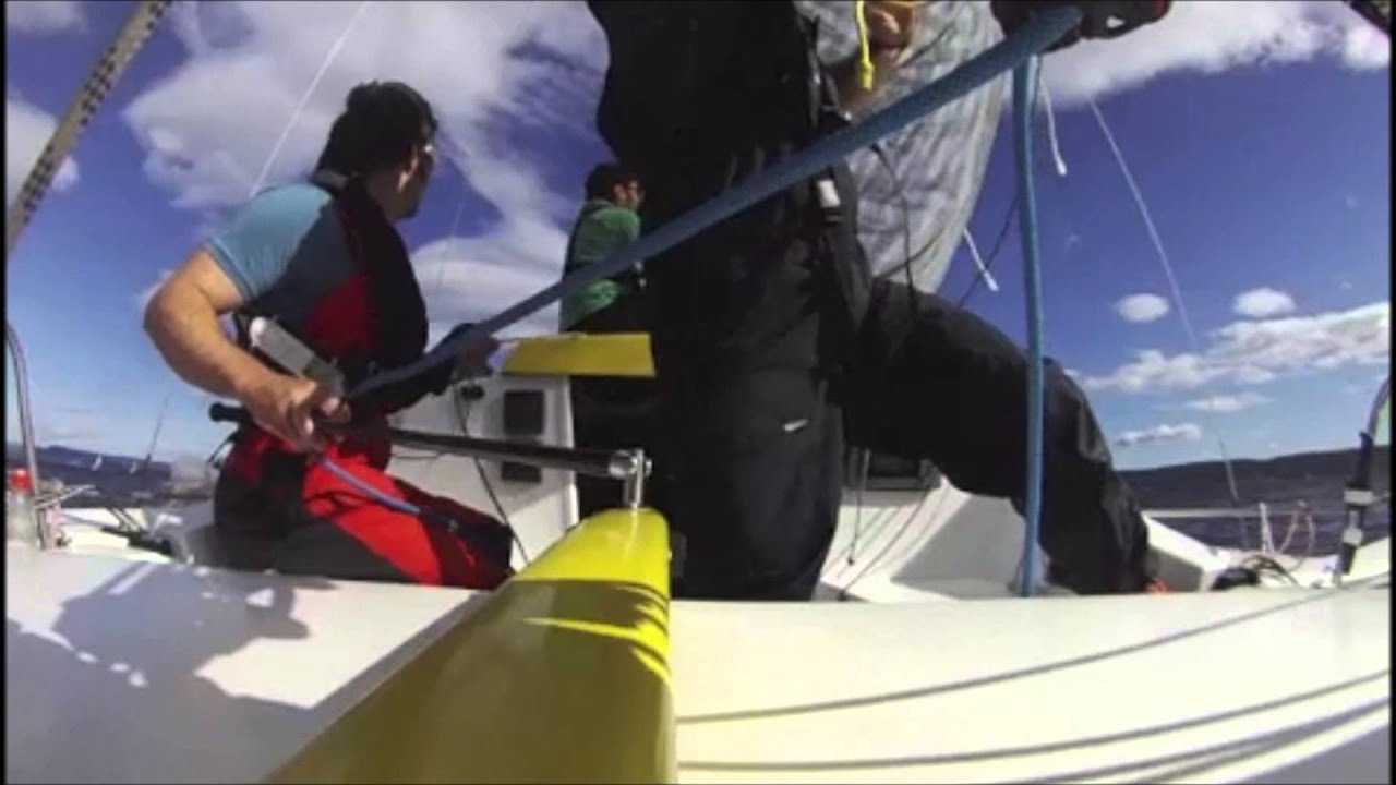 Reefing boomless main downwind - YouTube