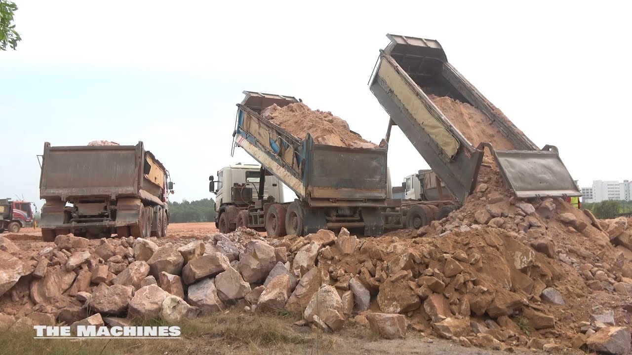 Land Filling with Rock Mountain Operation Dozer Move Rock Dump Truck ...