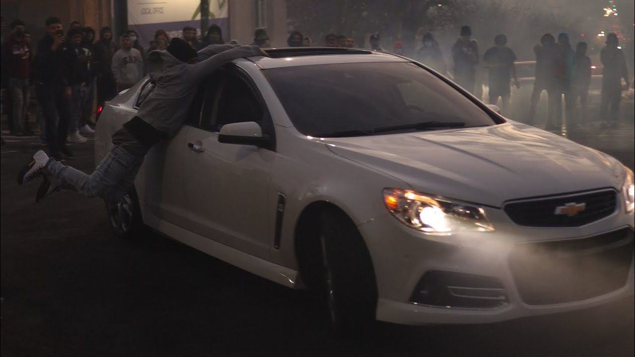 OAKLAND SIDESHOW!!! GUY HANGS OFF CHEVY SS!! - YouTube