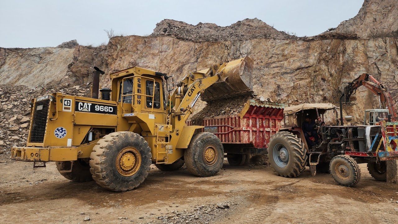 Caterpillar 966D Wheel Loader Loading Rocks On Massey Ferguson 385 ...