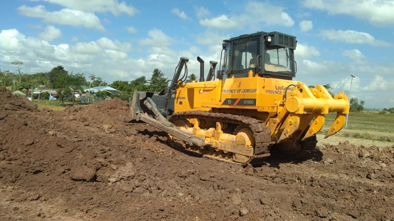 Dozer spread of materials for making road - YouTube